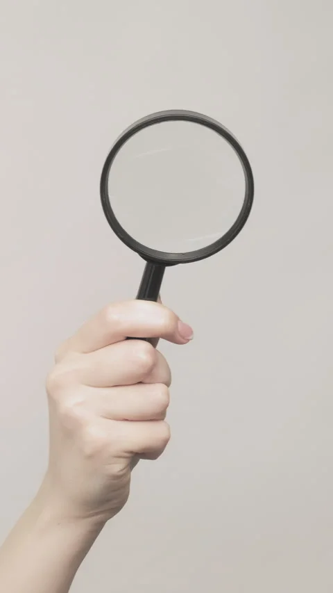 Vertical searching glass zooming loupe f... | Stock Video | Pond5