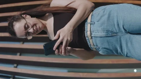 Vertical shooting of a young woman with ... | Stock Video | Pond5