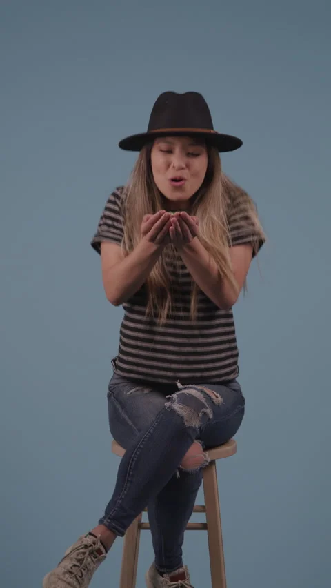 Vertical Shot of Cute Asian Female Blowi... | Stock Video | Pond5