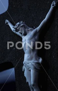 Vertical shot of a statue of Jesus Christ crucified on a black cross Stock Image #228958416