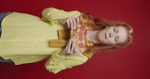 Vertical video Eating a tasty slice of P... | Stock Video | Pond5