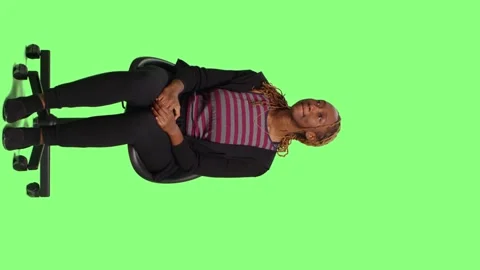 Vertical video: Female model sitting on ... | Stock Video | Pond5