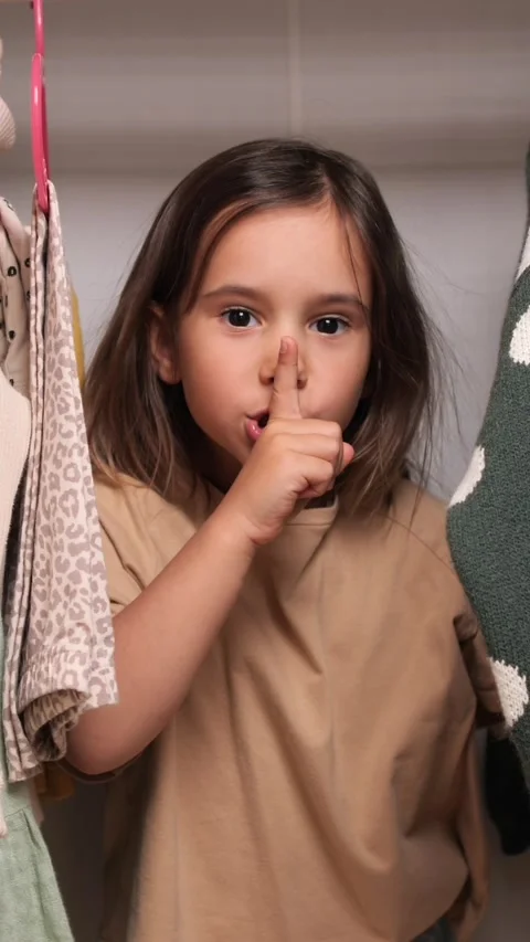 vertical video Girl hiding in closet mak... | Stock Video | Pond5