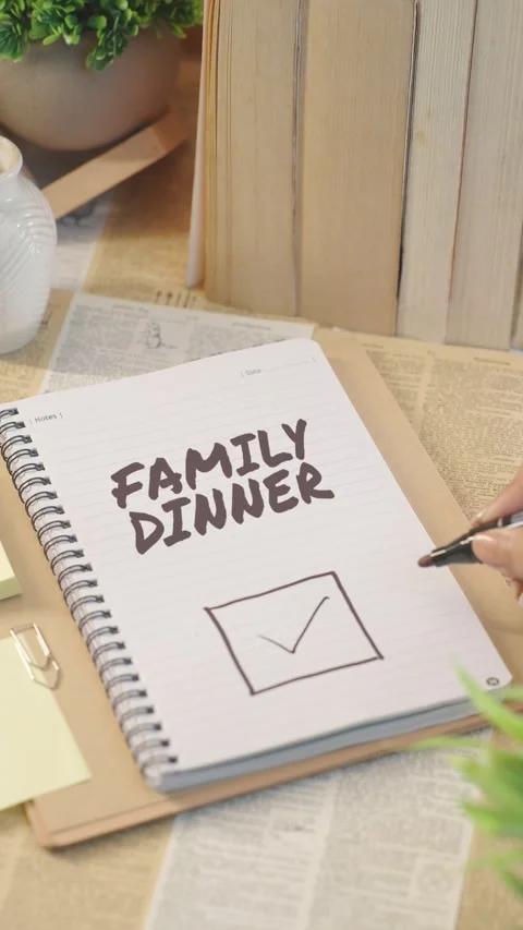 VERTICAL VIDEO OF TICKING OFF FAMILY DIN... | Stock Video | Pond5