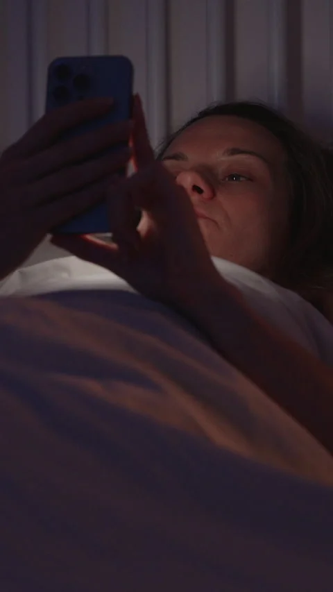 Vertical video. Woman Lying in Bed at Ni... | Stock Video | Pond5