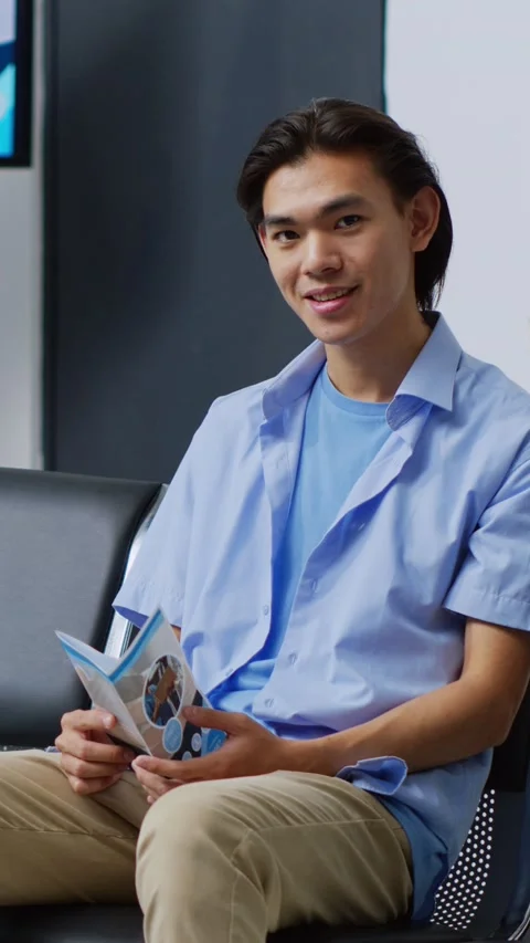 Vertical video: Young adult sitting on c... | Stock Video | Pond5