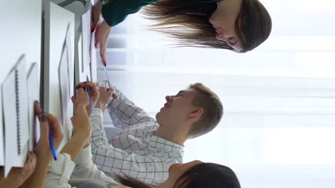 Vertical: Young teacher chek and control... | Stock Video | Pond5