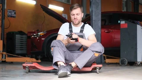 A very angry young car mechanic sitting ... | Stock Video | Pond5