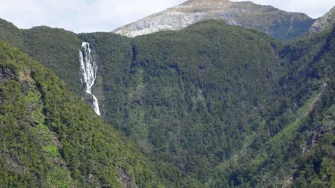 a very distant pretty waterfall in Fiord... | Stock Video | Pond5
