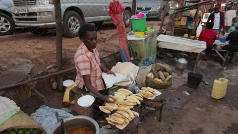 Very poor black woman is selling grilled... | Stock Video | Pond5