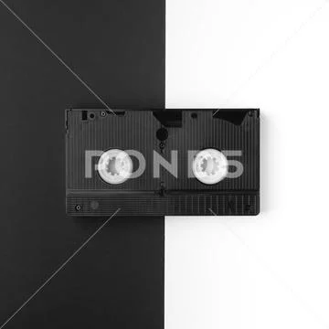 The VHS cassette lies on a black and white table. Stock Image #141664721