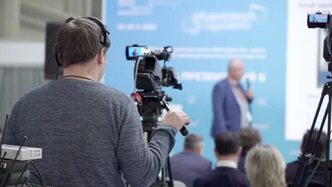 Video engineer filming the speakers in t... | Stock Video | Pond5