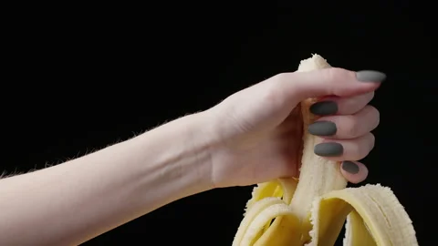 Video of female hand squashing banana | Stock Video | Pond5