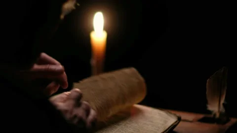 Video of old monk reading old book in da... | Stock Video | Pond5