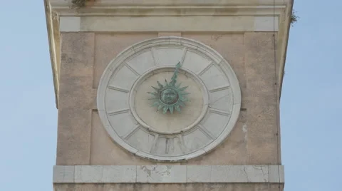 View of a clock tower with sun shaped cl... | Stock Video | Pond5