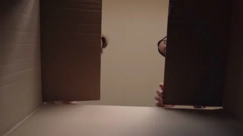 View from inside a cardboard box on two ... | Stock Video | Pond5
