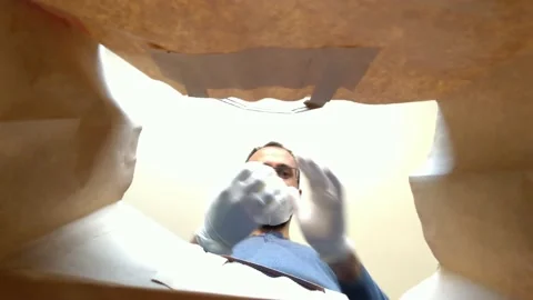 View from inside a paper bag of a man wi... | Stock Video | Pond5