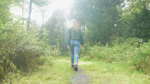 View from low behind girl walking on nat... | Stock Video | Pond5
