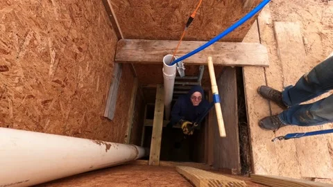 View of man working on the bottom of hol... | Stock Video | Pond5