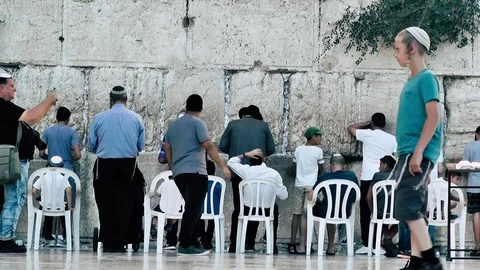 view of people praying front the wailing... | Stock Video | Pond5