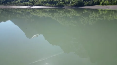 View of the reflection on the water surf... | Stock Video | Pond5