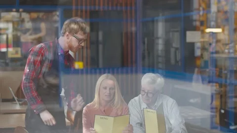 View through window of waiter helping se... | Stock Video | Pond5