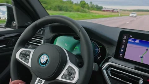 View of woman driver driving new BMW iX... | Stock Video | Pond5