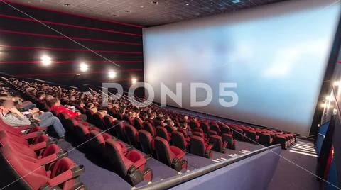 Viewers watch motion picture at movie theatre timelapse Stock Image ...