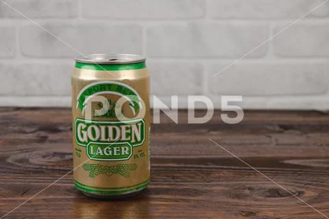 A vintage aluminium can of Golden Lager beer against the brick wall ...