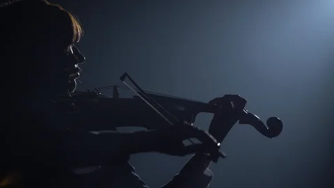 Violinist performing in a dark studio wi... | Stock Video | Pond5