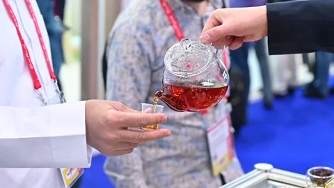 A visitor getting a free tea sample duri... | Stock Video | Pond5