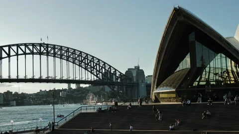 Visitors sit on steps of the Opera House... | Stock Video | Pond5