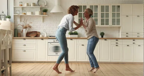 Vivacious young woman dancing in kitchen... | Stock Video | Pond5