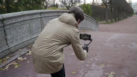 Vlogger boy with mobile phone camera sta... | Stock Video | Pond5