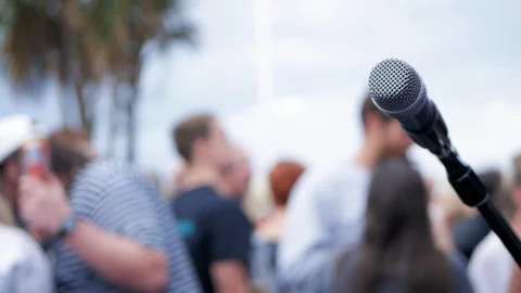Vocal microphone in focus with crowd of ... | Stock Video | Pond5