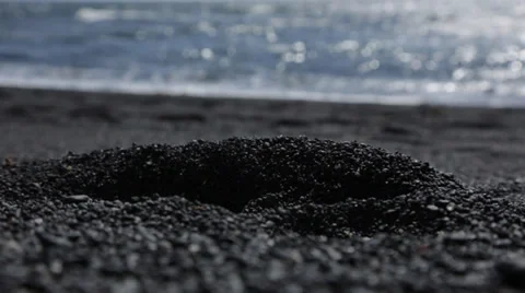 Volcanic Black Sand with beach in backgr... | Stock Video | Pond5