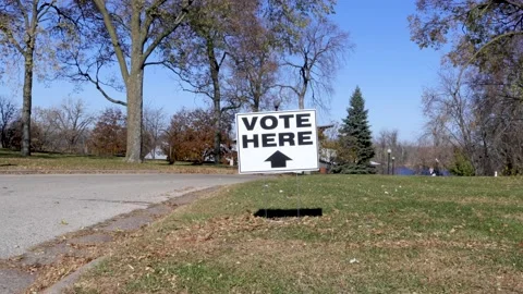 Vote here voting sign on the lawn | Stock Video | Pond5