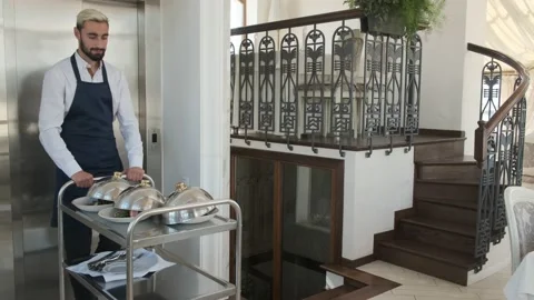 Waiter carries a cart of food from the e... | Stock Video | Pond5