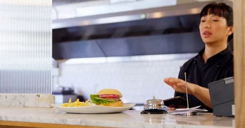 Waitress ringing order bell at counter 4... | Stock Video | Pond5