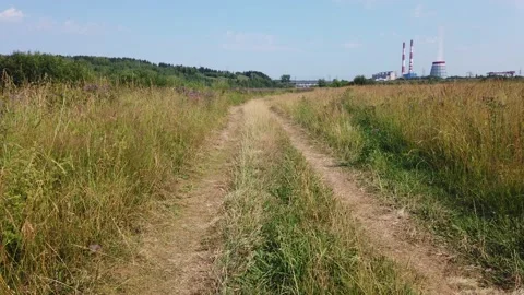 Walk in the field in summer. Power plant... | Stock Video | Pond5