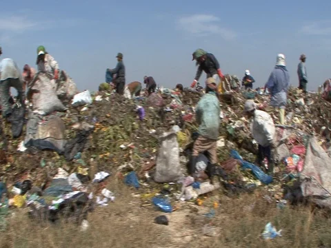 Walk-by of people picking trough garbage... | Stock Video | Pond5