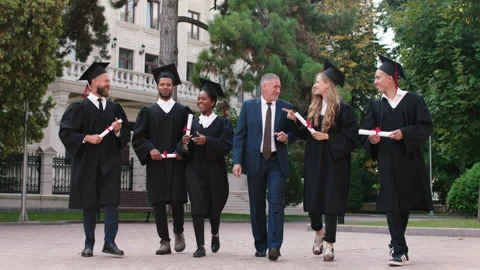 Walking in front of the camera graduates... | Stock Video | Pond5