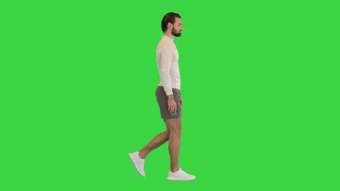 Walking handsome guy in motion on a Gree... | Stock Video | Pond5