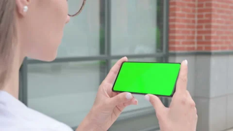 Walking Woman Watching Smartphone with G... | Stock Video | Pond5