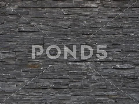 Wall with decorative dark gray rough tiled cladding. Texture not ...