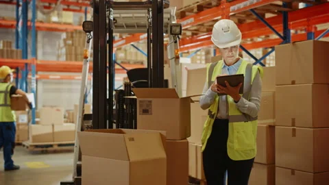 Warehouse Female Worker Checks Goods in ... | Stock Video | Pond5