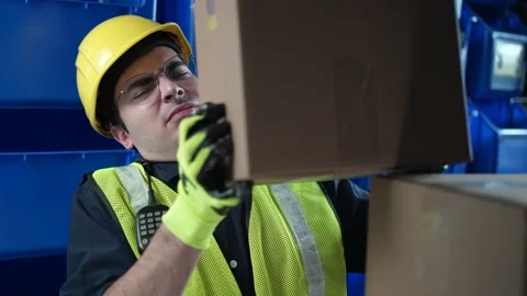 Warehouse Worker Lifting a Very Heavy Bo... | Stock Video | Pond5