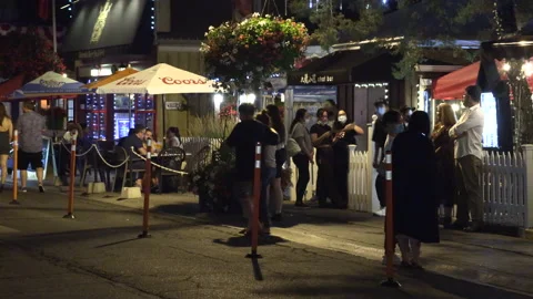 Warm ummer night with people walking and... | Stock Video | Pond5