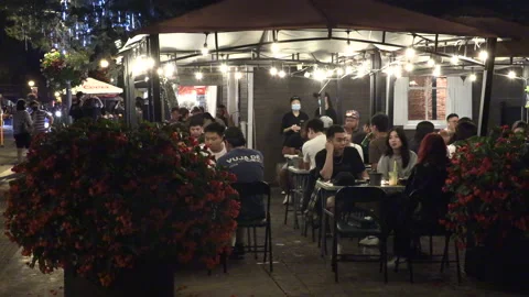 Warm ummer night with people walking and... | Stock Video | Pond5