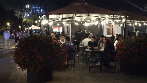 Warm ummer night with people walking and... | Stock Video | Pond5